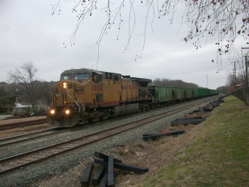 UP 6860 19Feb2010 SB Approaching Uhland Road with MOW hoppers with ballast